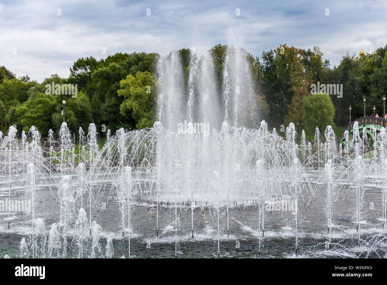 Splashing water of fountain inject from ground showing in public park ...