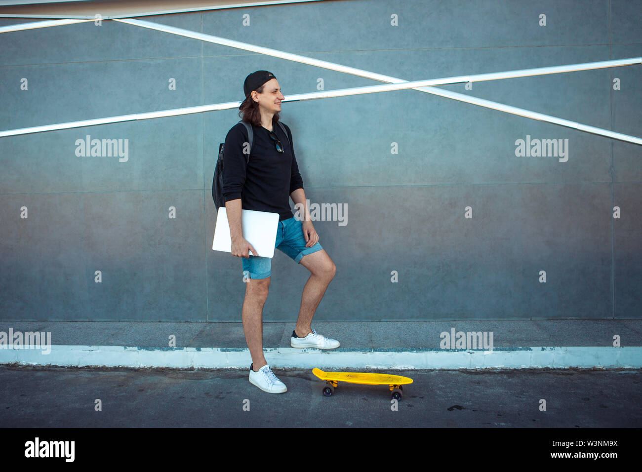 Man holding laptop under arm hi-res stock photography and images - Alamy