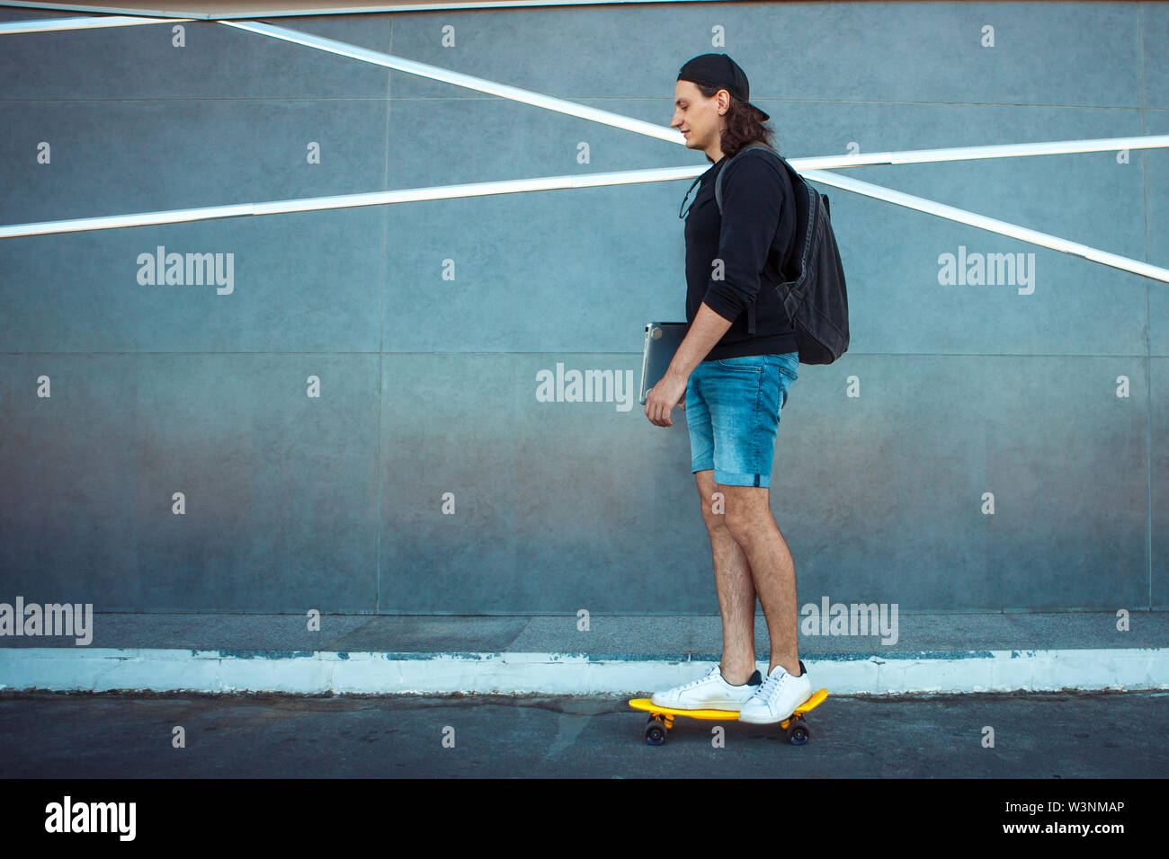 Man holding laptop under arm hi-res stock photography and images - Alamy