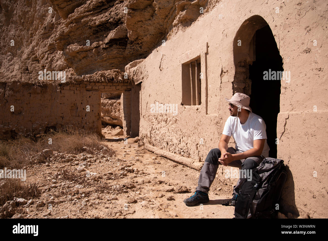 backpacker traveler with hat and white shirt Stock Photo - Alamy