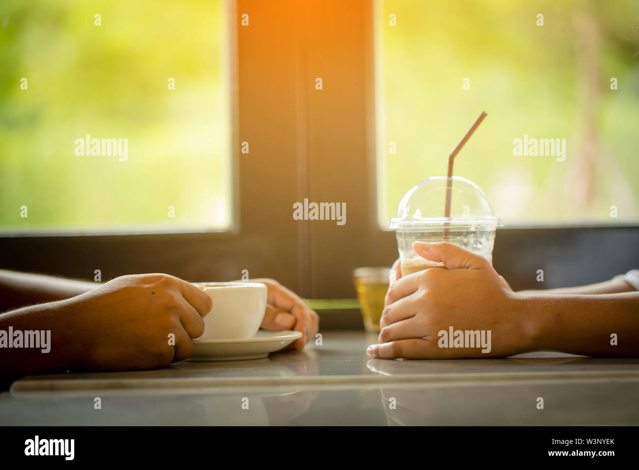 couple drinking hot and cold coffee Stock Photo - Alamy