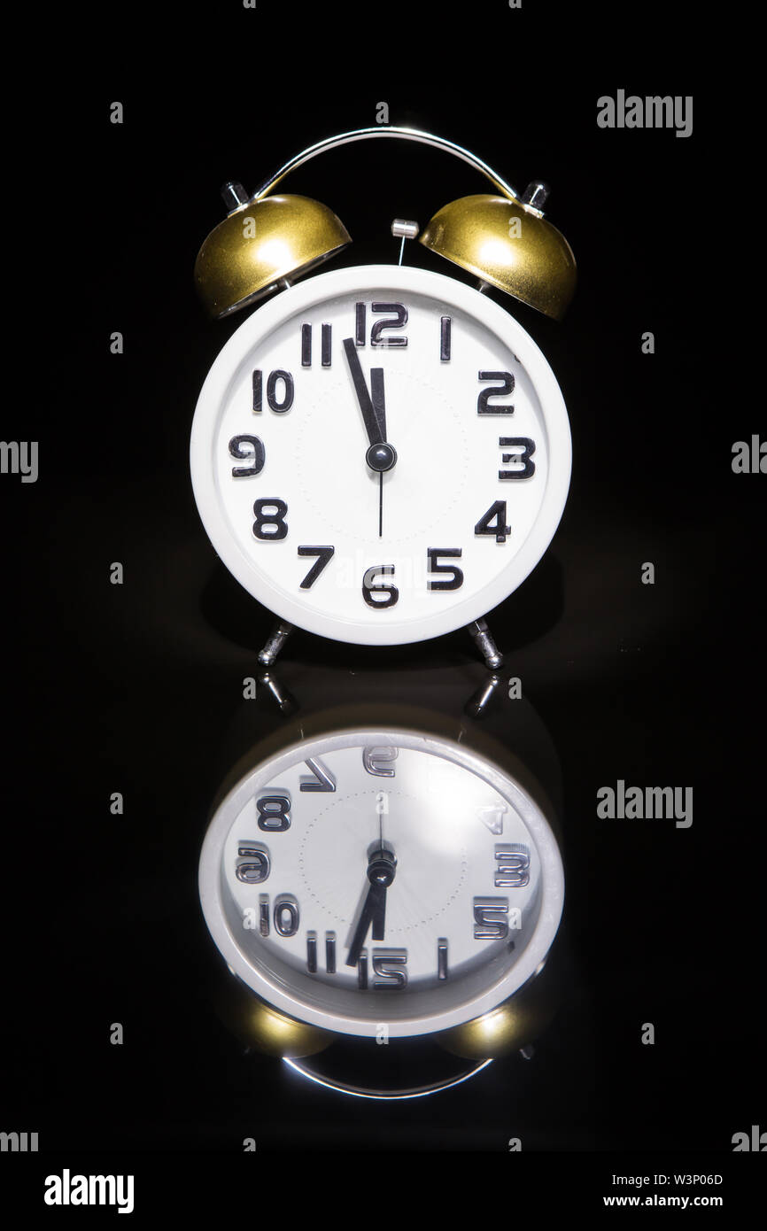 Alarm clock with dark background and reflection Stock Photo - Alamy