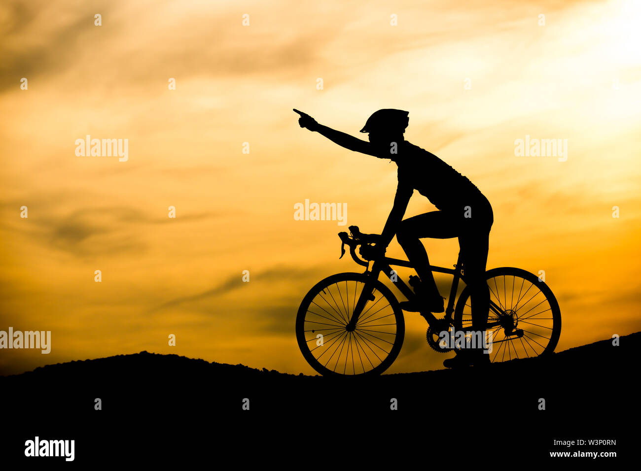 cyclist and sunset background Stock Photo - Alamy