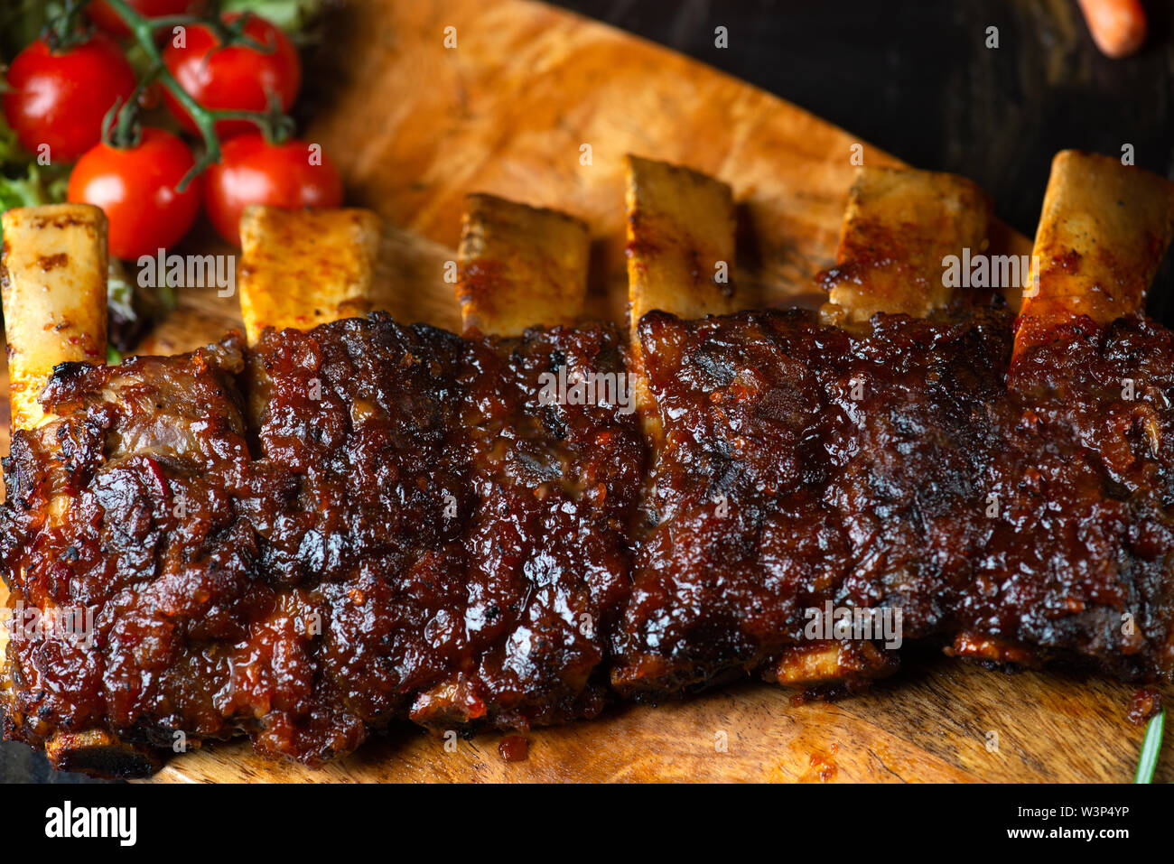 BBQ beef ribs steak served with a hot chili pepper and fresh tomatoes ...