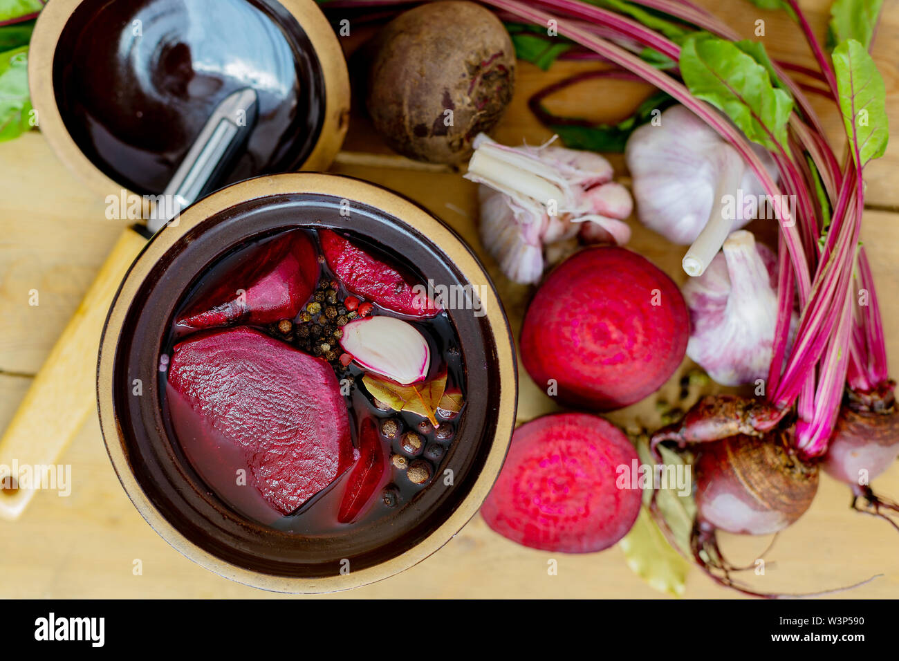 Dish with pickled beets. Rural wooden table. Preparation of borscht ...