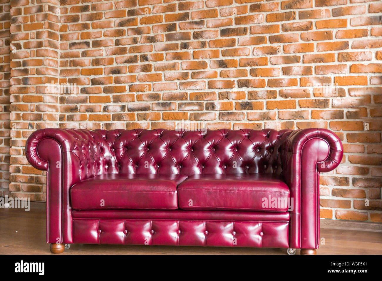 Sofa red brick wall interior hi-res stock photography and images - Alamy