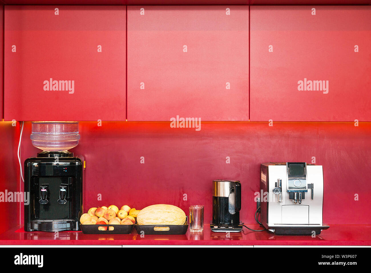 Photo of Kitchen with coffee machine, cooler and fruit Stock Photo - Alamy