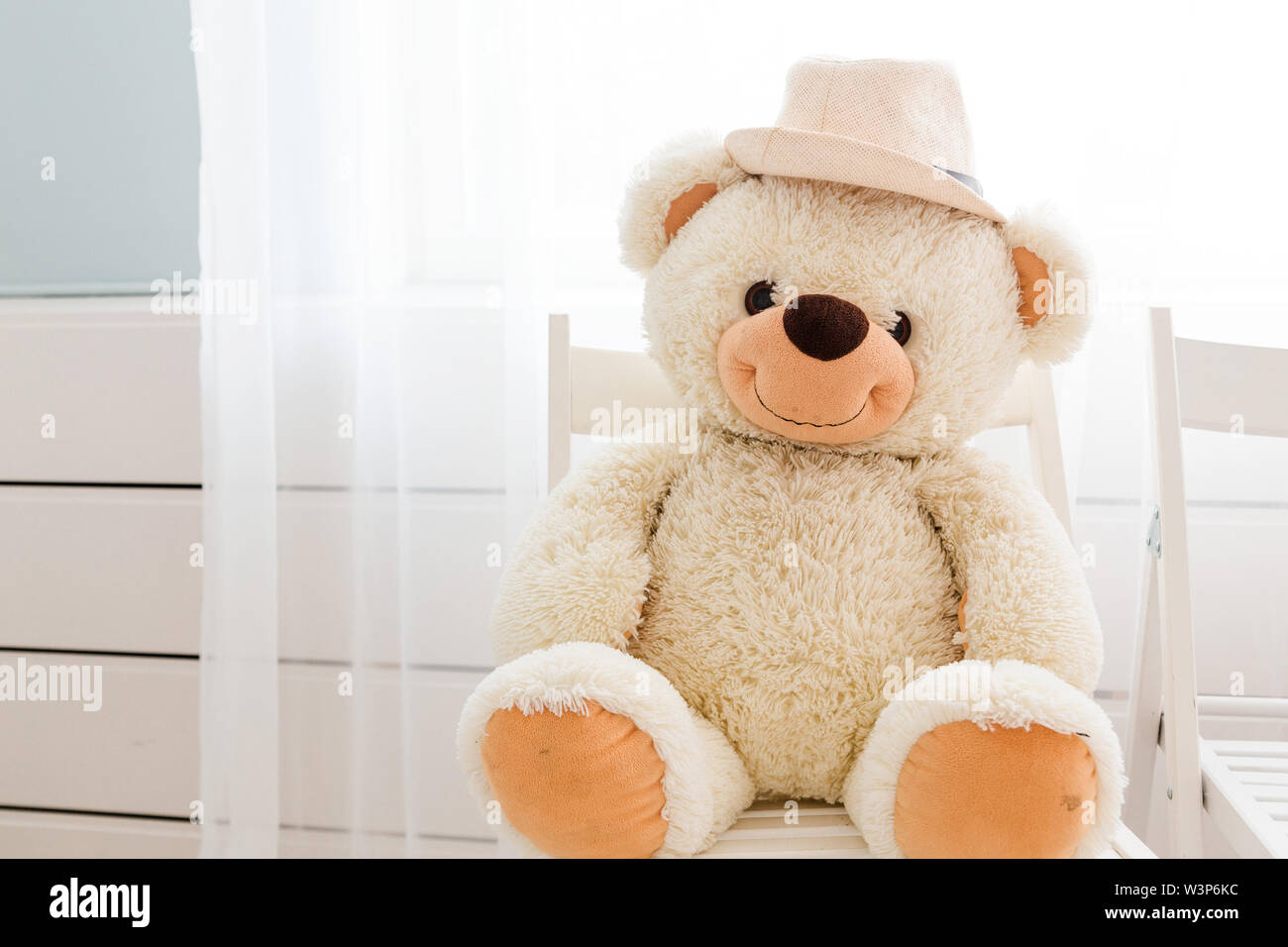 Teddy bear sitting on chair hi-res stock photography and images - Alamy