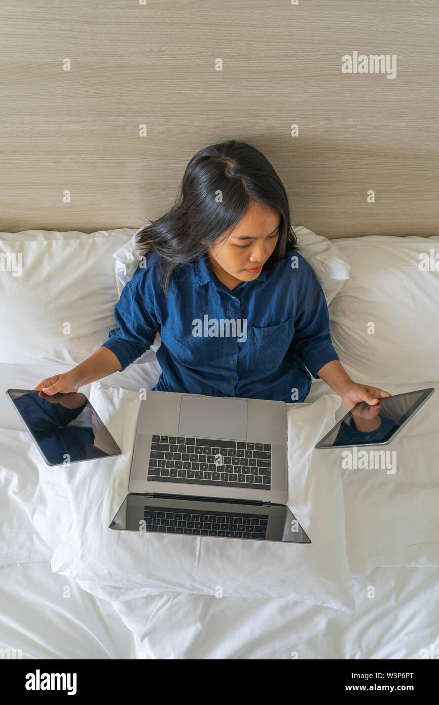 Woman working multiple tasks with devices laptop and tablet Stock Photo ...