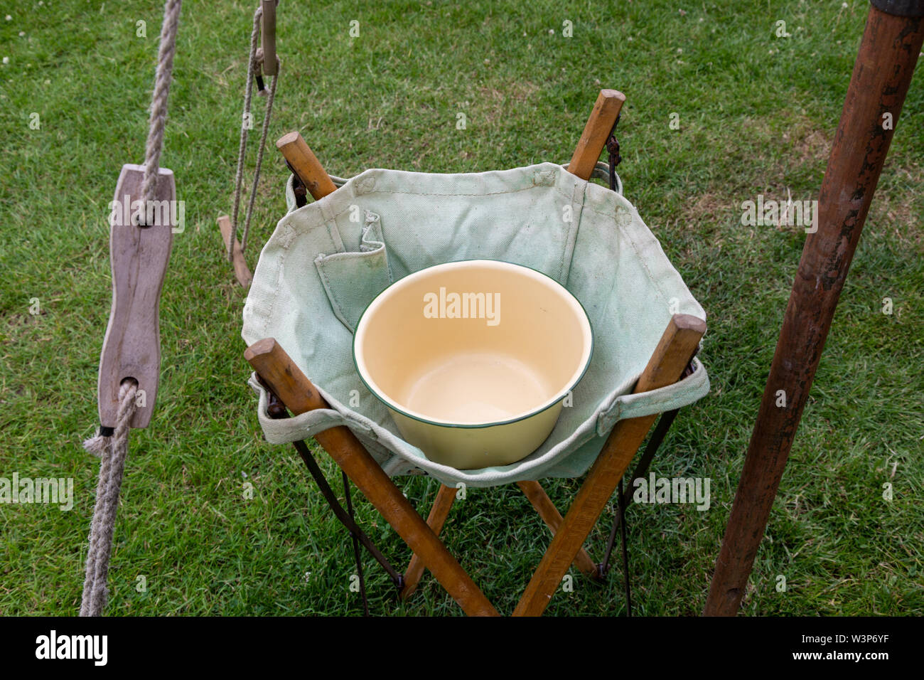 Old fashioned camping device holding a washing bowl Stock Photo - Alamy