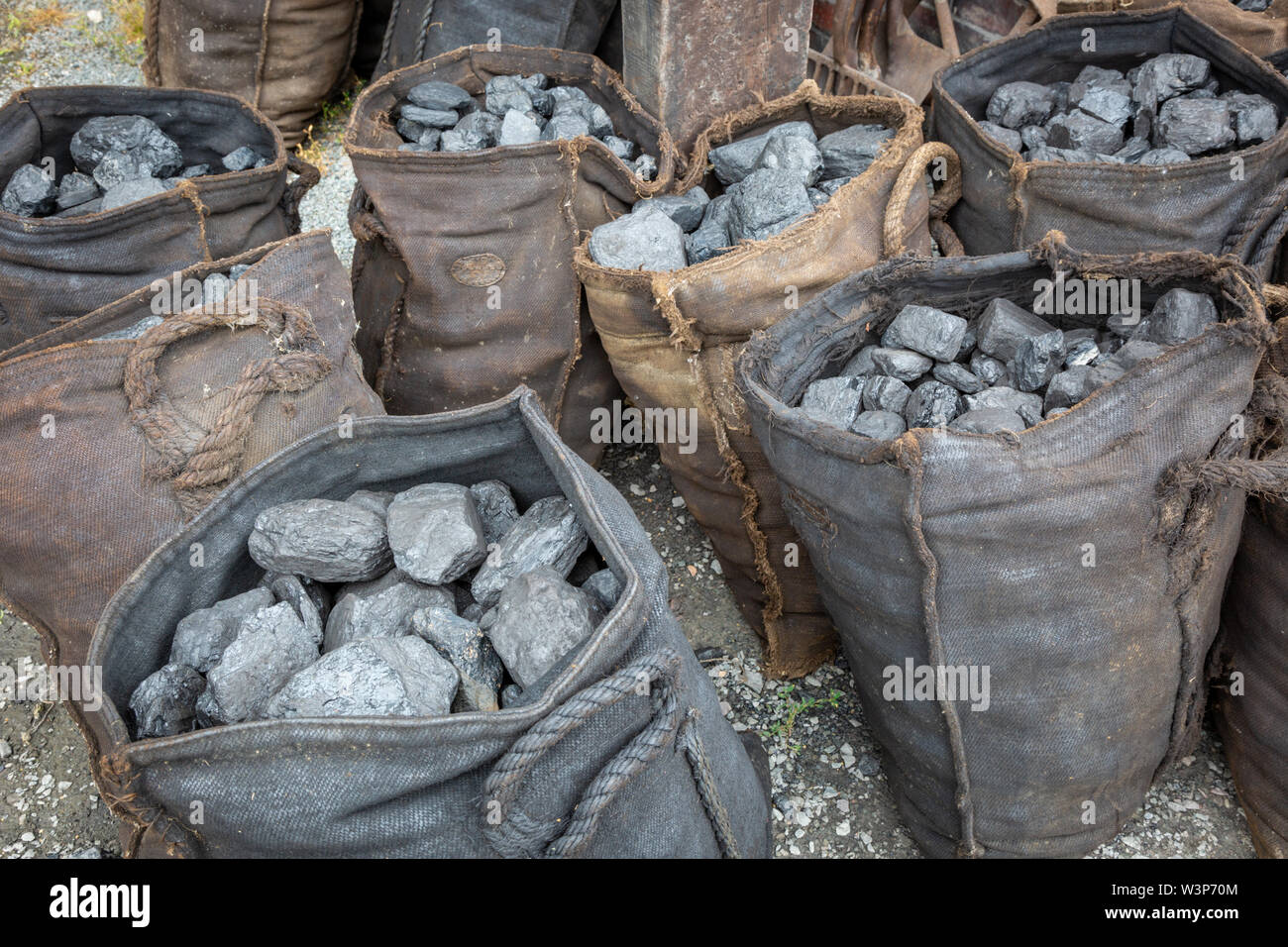 Sacks of coal outside in a yard Stock Photo - Alamy