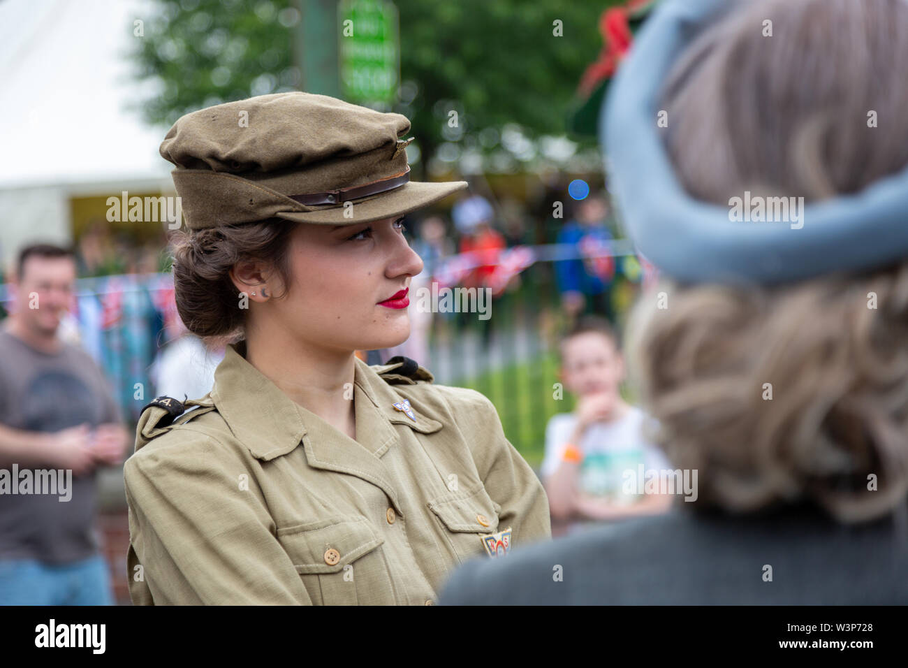 People dressed in wartime clothes at a 1940s event, UK Stock Photo - Alamy