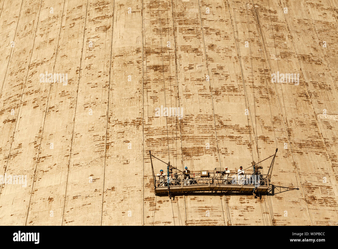 Workmen on a high rise platform on a cooling tower of Dukovany power ...