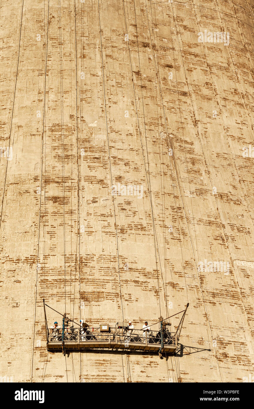 Workmen on a high rise platform on a cooling tower of Dukovany power ...