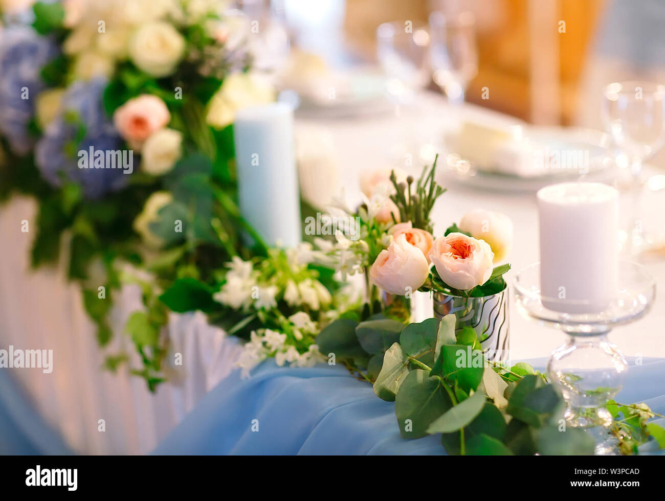 Wedding table settings. Empty plates and glasses on a white tablecloth ...