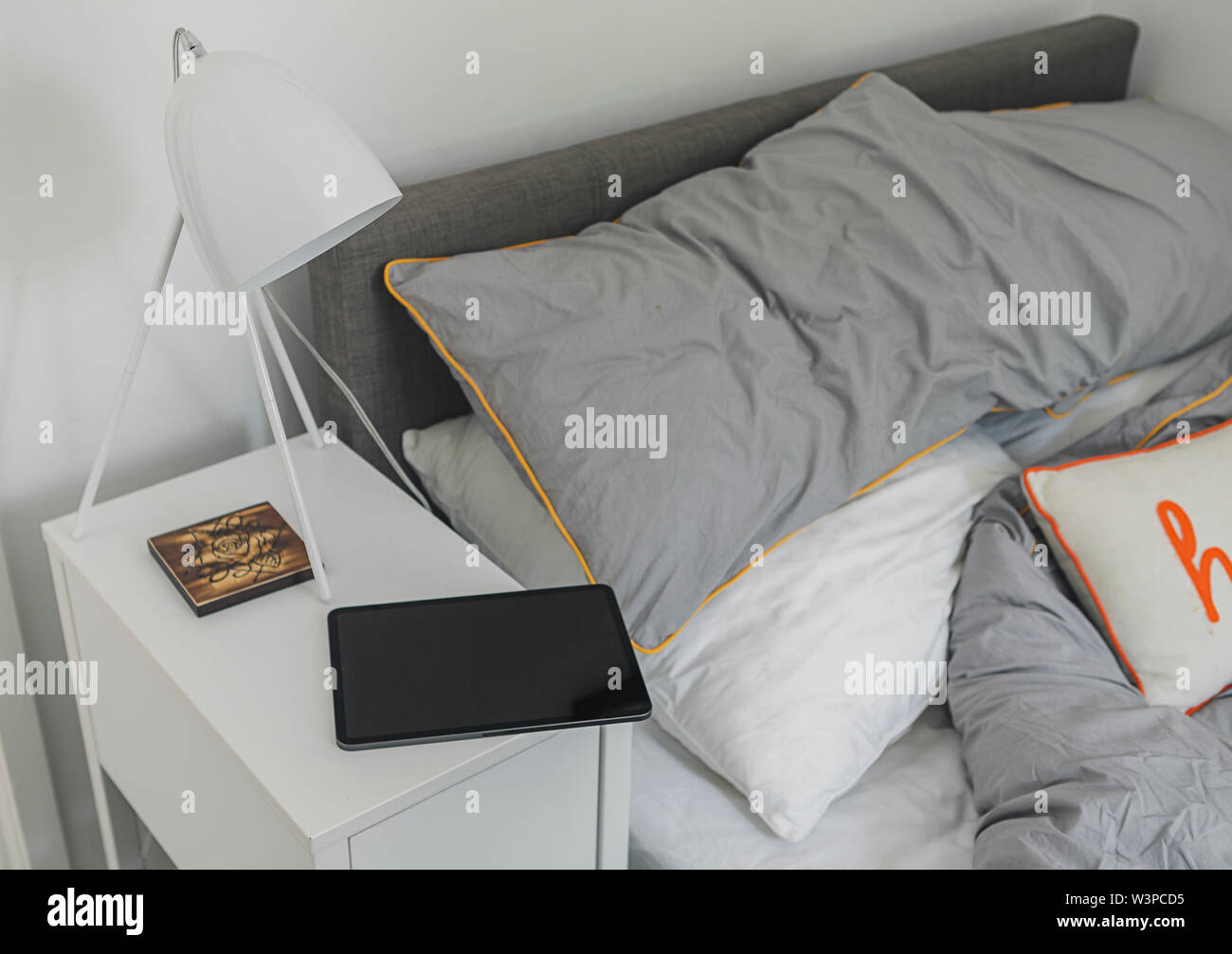 Tablet computer next to the bed Stock Photo - Alamy
