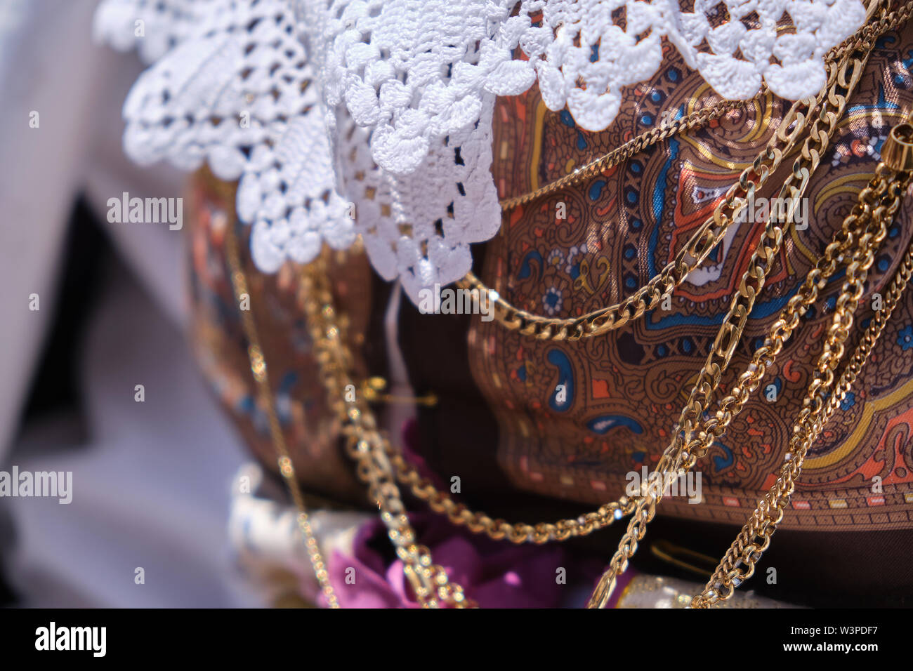 A woman dressed in typical Sardinian costume with different Sardinian ...