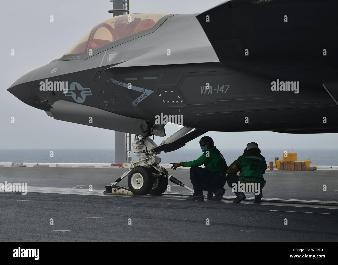 190712-N-NI812-00278 PACIFIC OCEAN (July 12, 2019) Sailors move an F-35C Lightning II assigned ...
