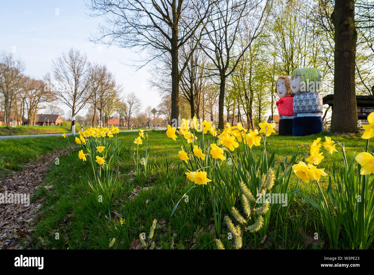 Humans from hay bales stand at the roadside Stock Photo - Alamy