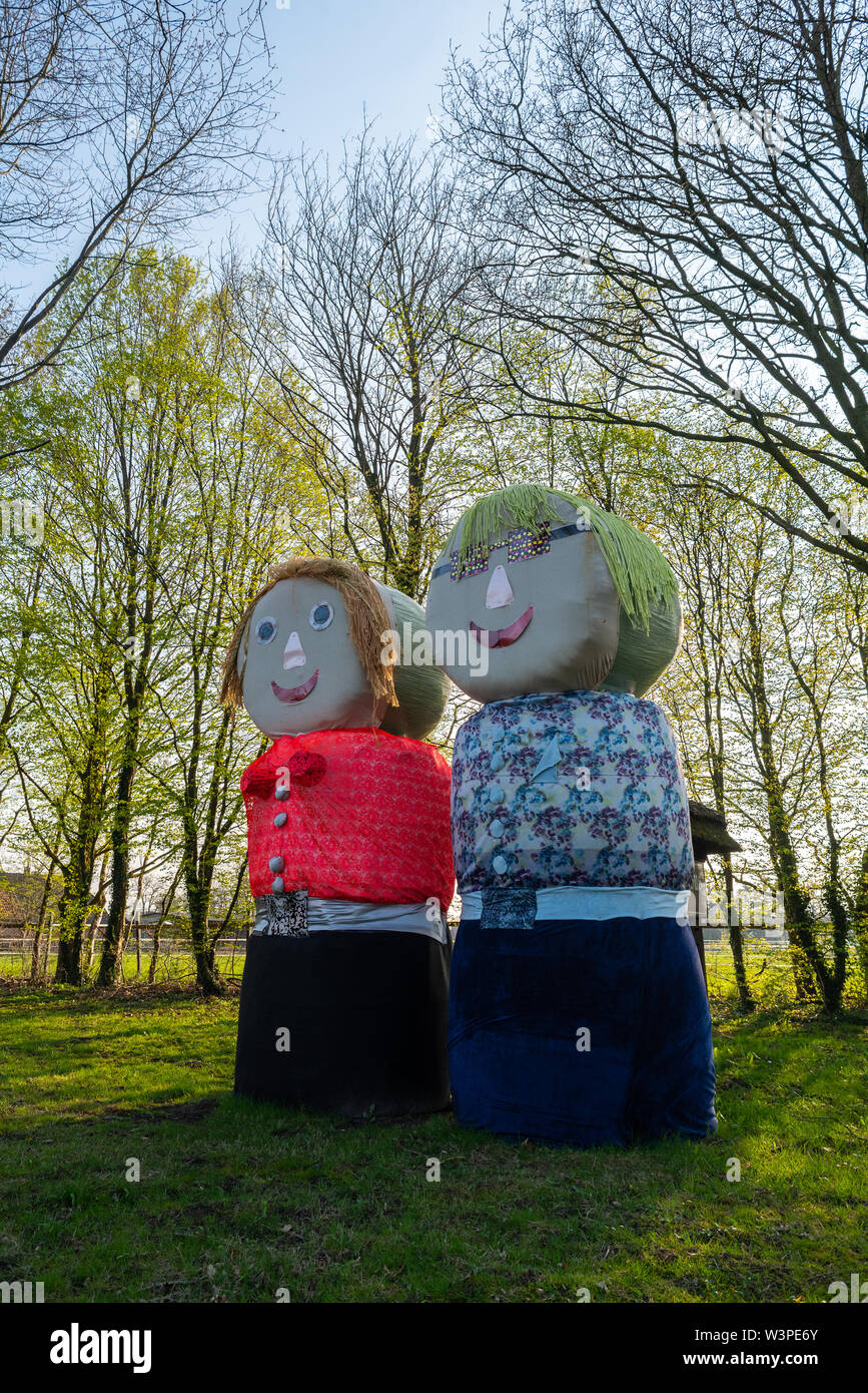 Humans from hay bales stand at the roadside Stock Photo - Alamy