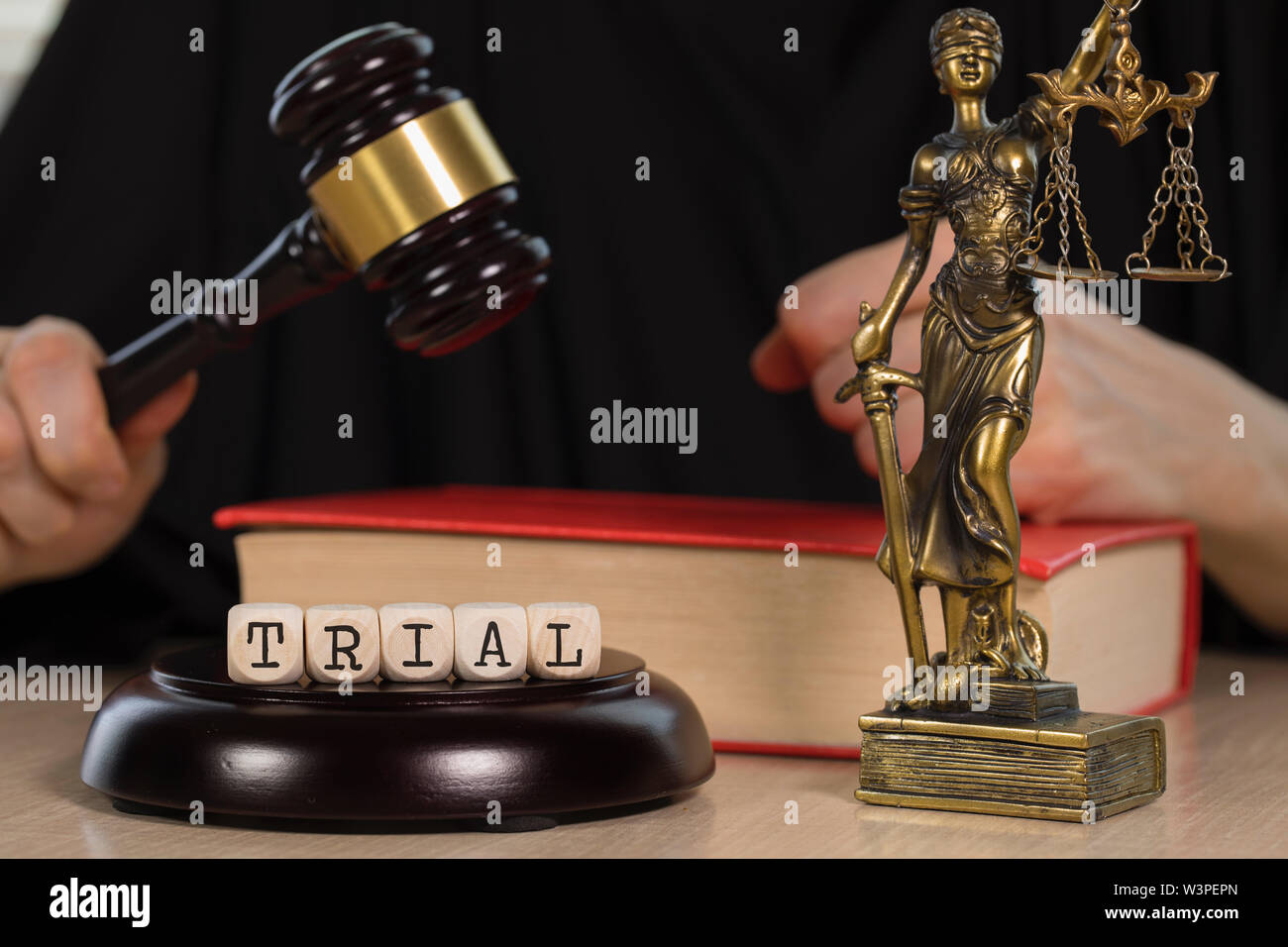 Word TRIAL composed of wooden dices. Wooden gavel and statue of Themis ...