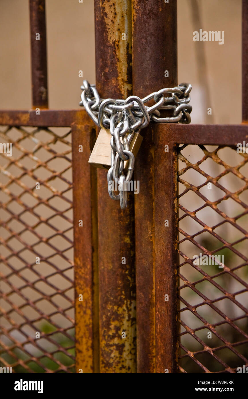 Metal gate closed with padlock - concept image Stock Photo - Alamy