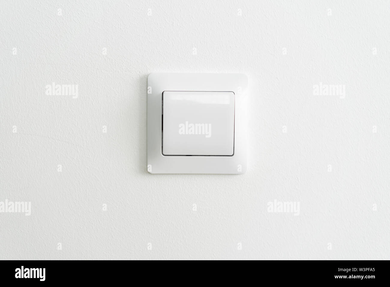 white modern light switch on white wall Stock Photo - Alamy