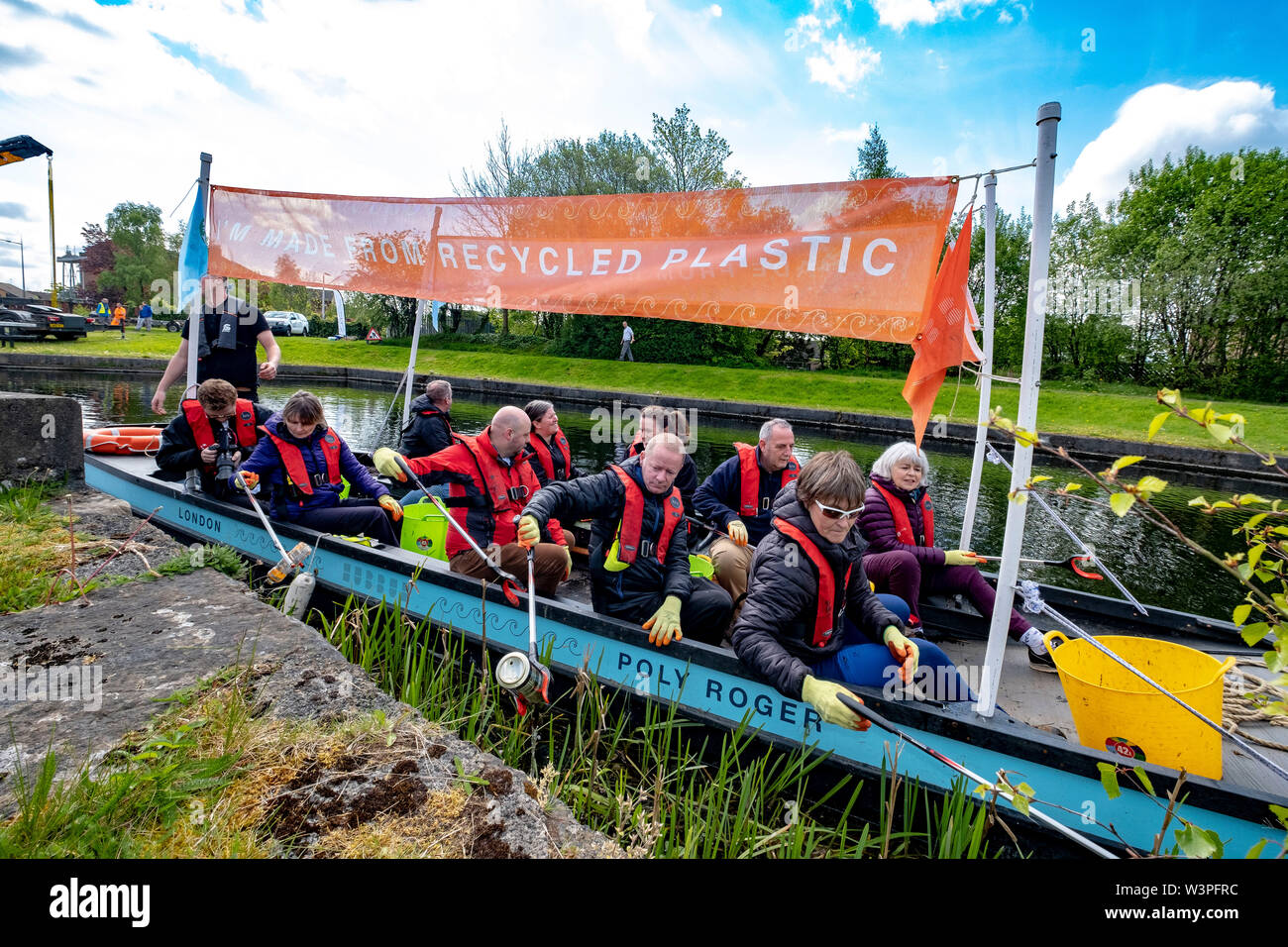 Volunteers picking up litter along canal bank Stock Photo - Alamy