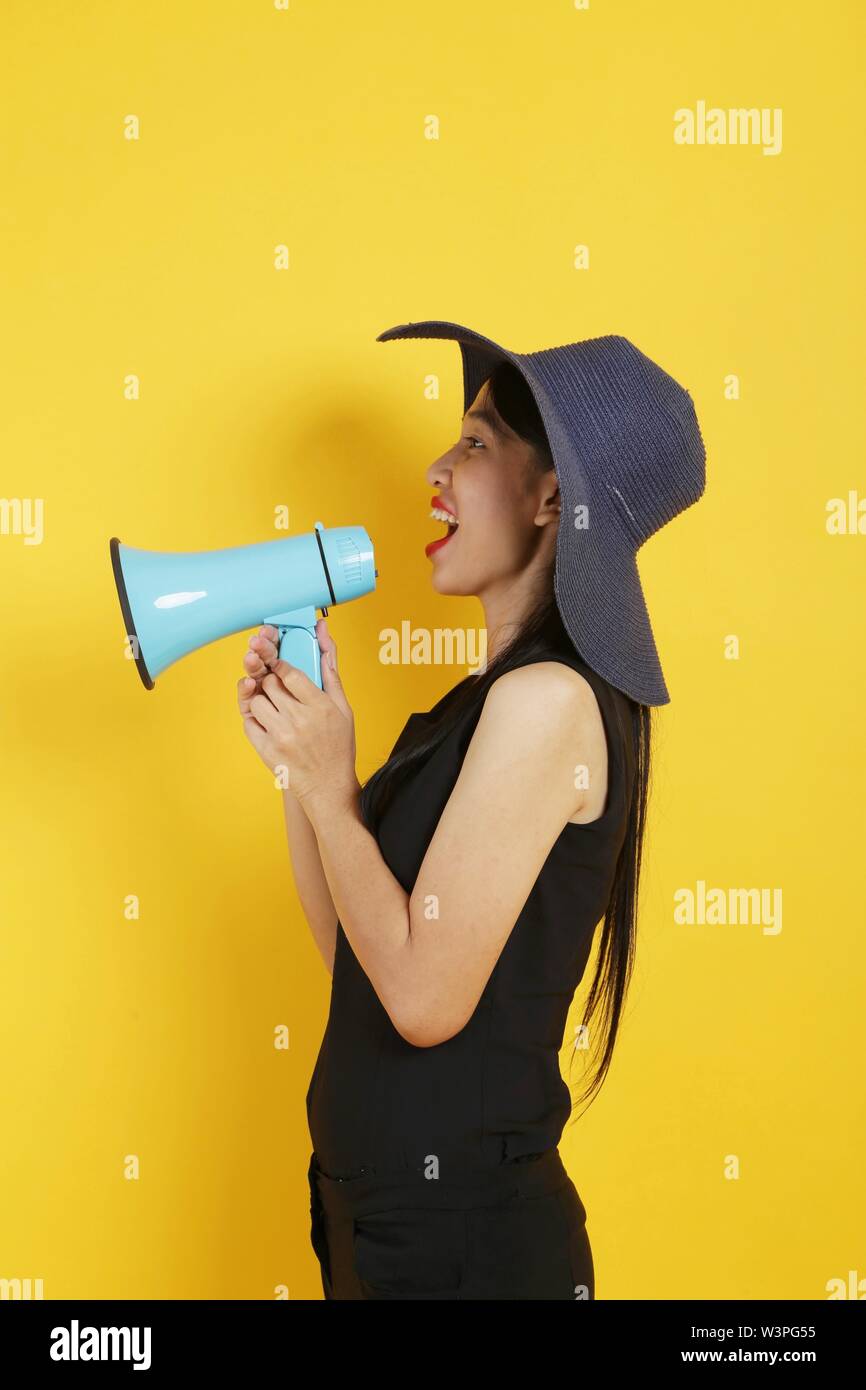 Beauty young attractive asian women shout out through megaphone in big ...