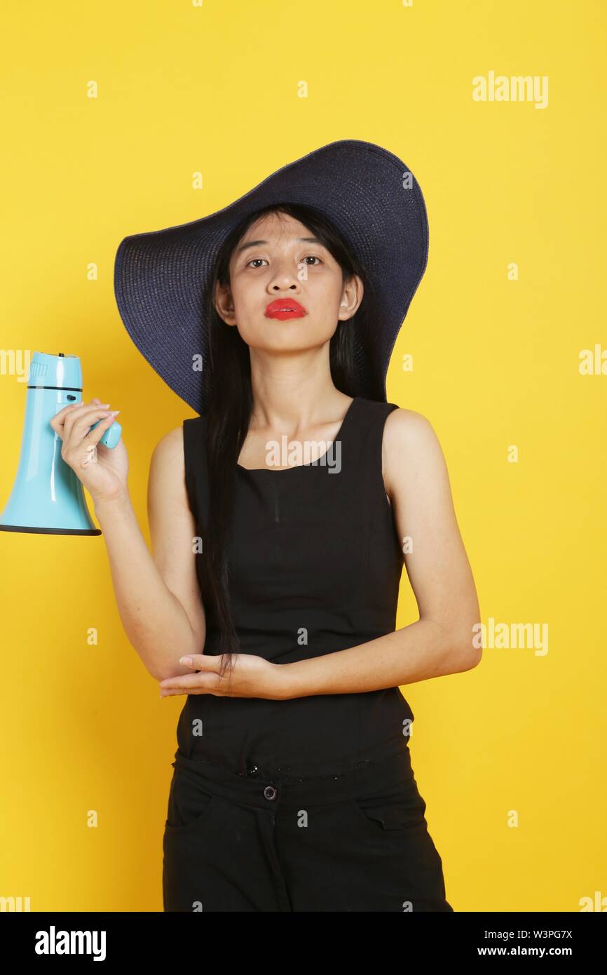Beauty young attractive asian women shout out through megaphone in big ...