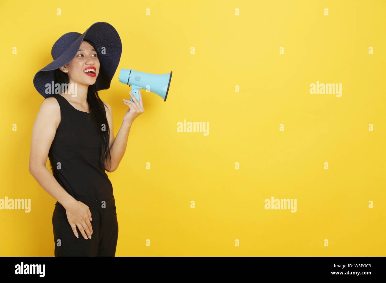 Beauty young attractive asian women shout out through megaphone in big ...