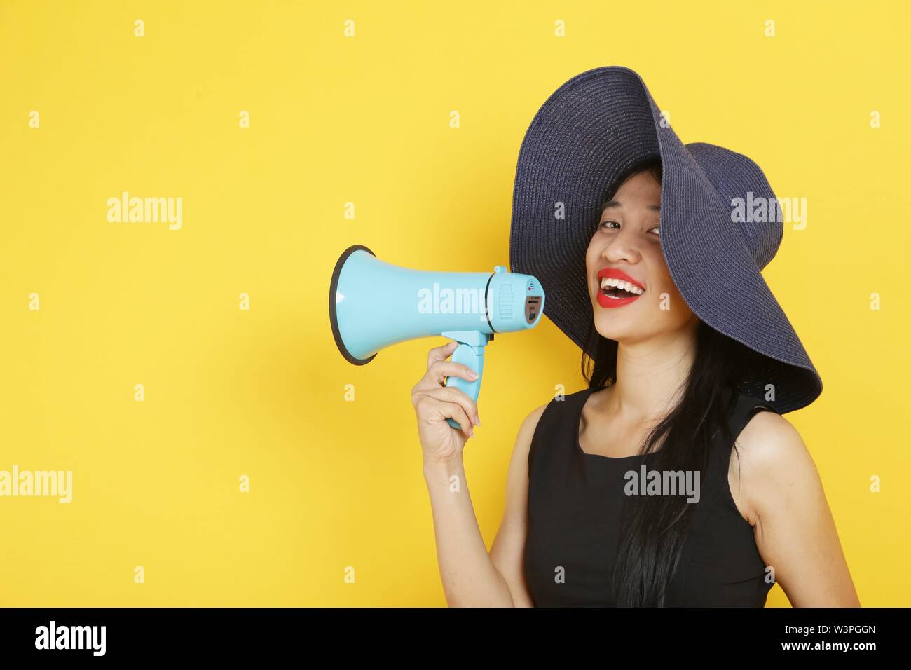 Beauty young attractive asian women shout out through megaphone in big ...