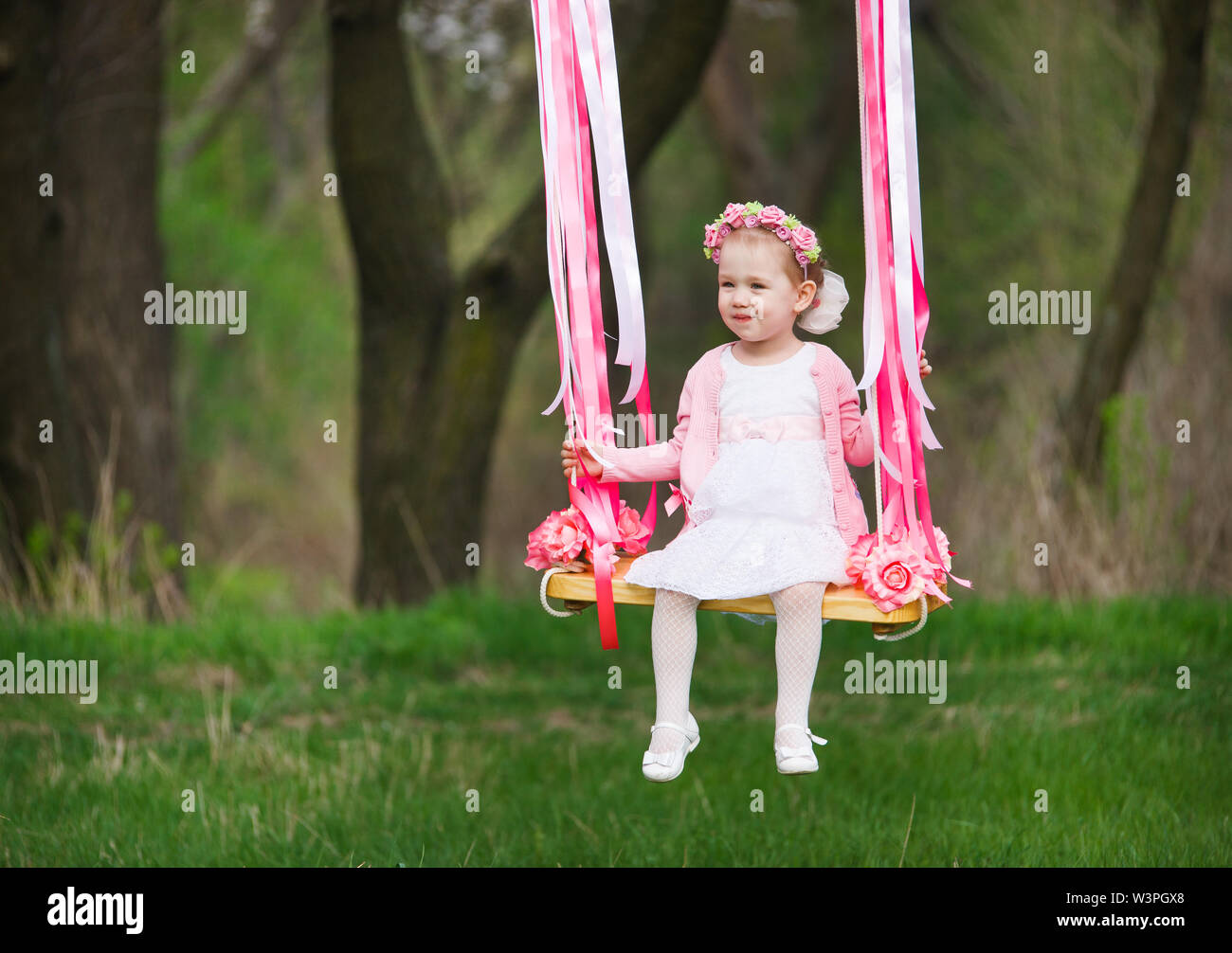 little cute girl on the swing, little girl at park Stock Photo - Alamy