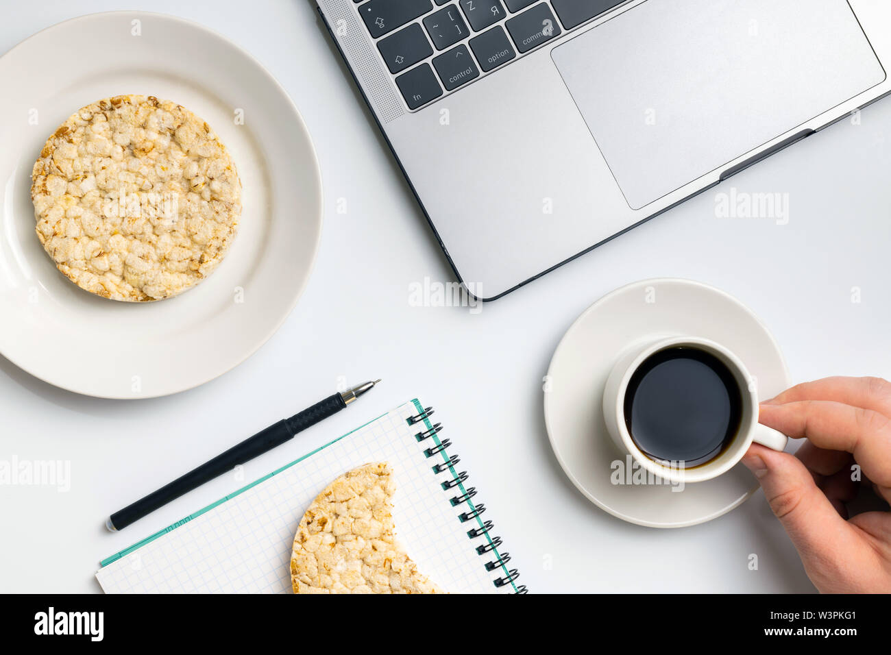 Healthy snacking at work during break time. Sportsman eating crispy ...