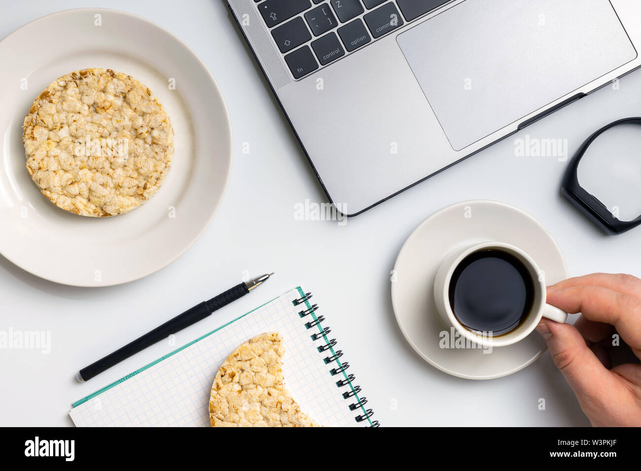 Healthy snacking at work during break time. Sportsman eating crispy ...