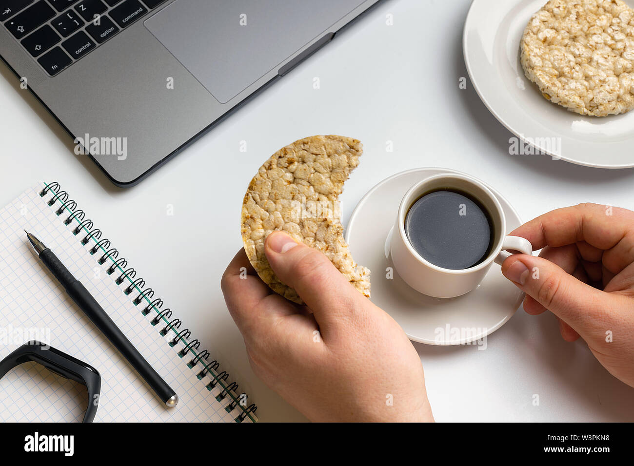 Healthy snacking at work during break time. Sportsman eating crispy ...