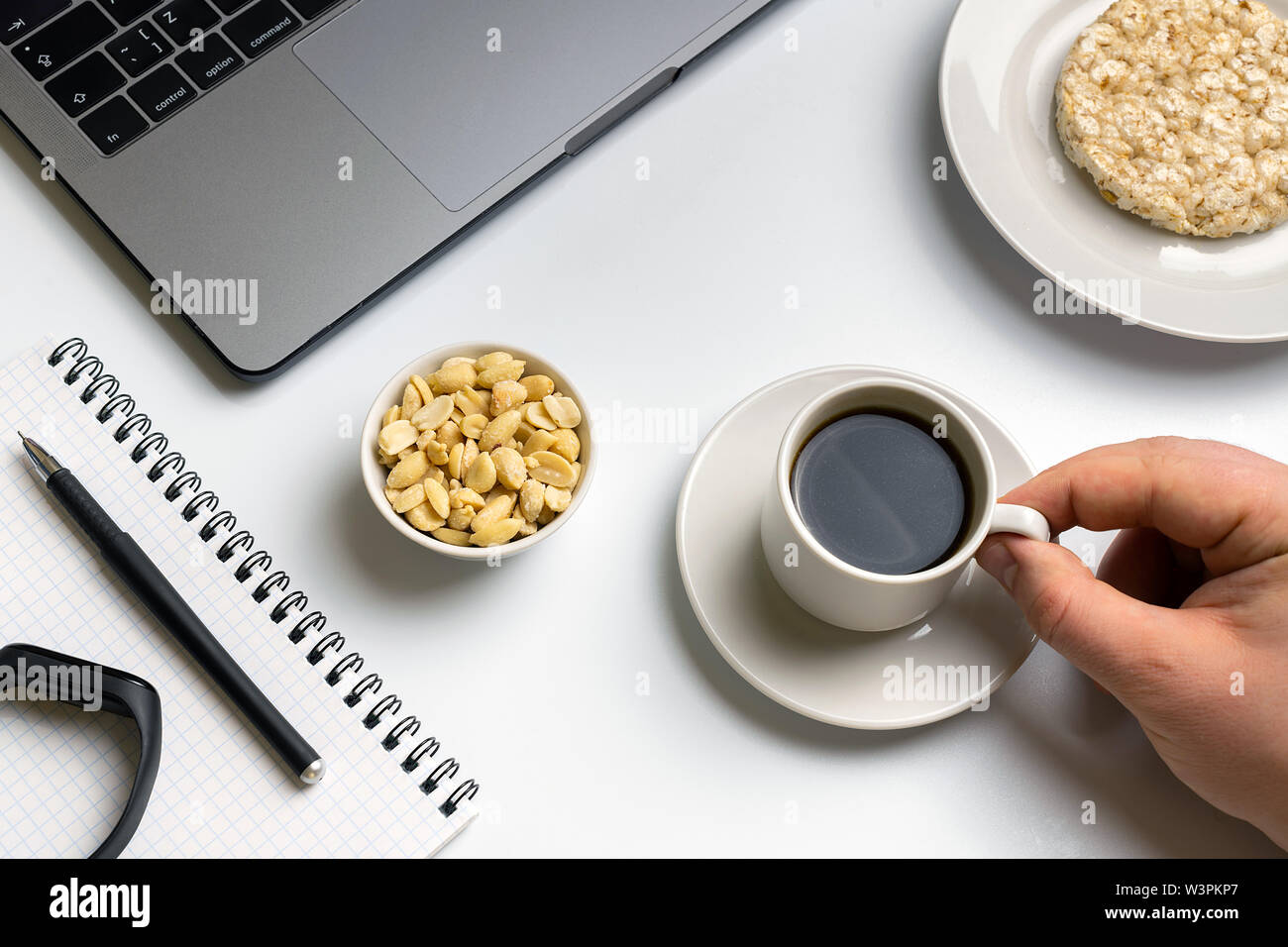 Healthy snacking at work during break time. Sportsman eating crispy ...