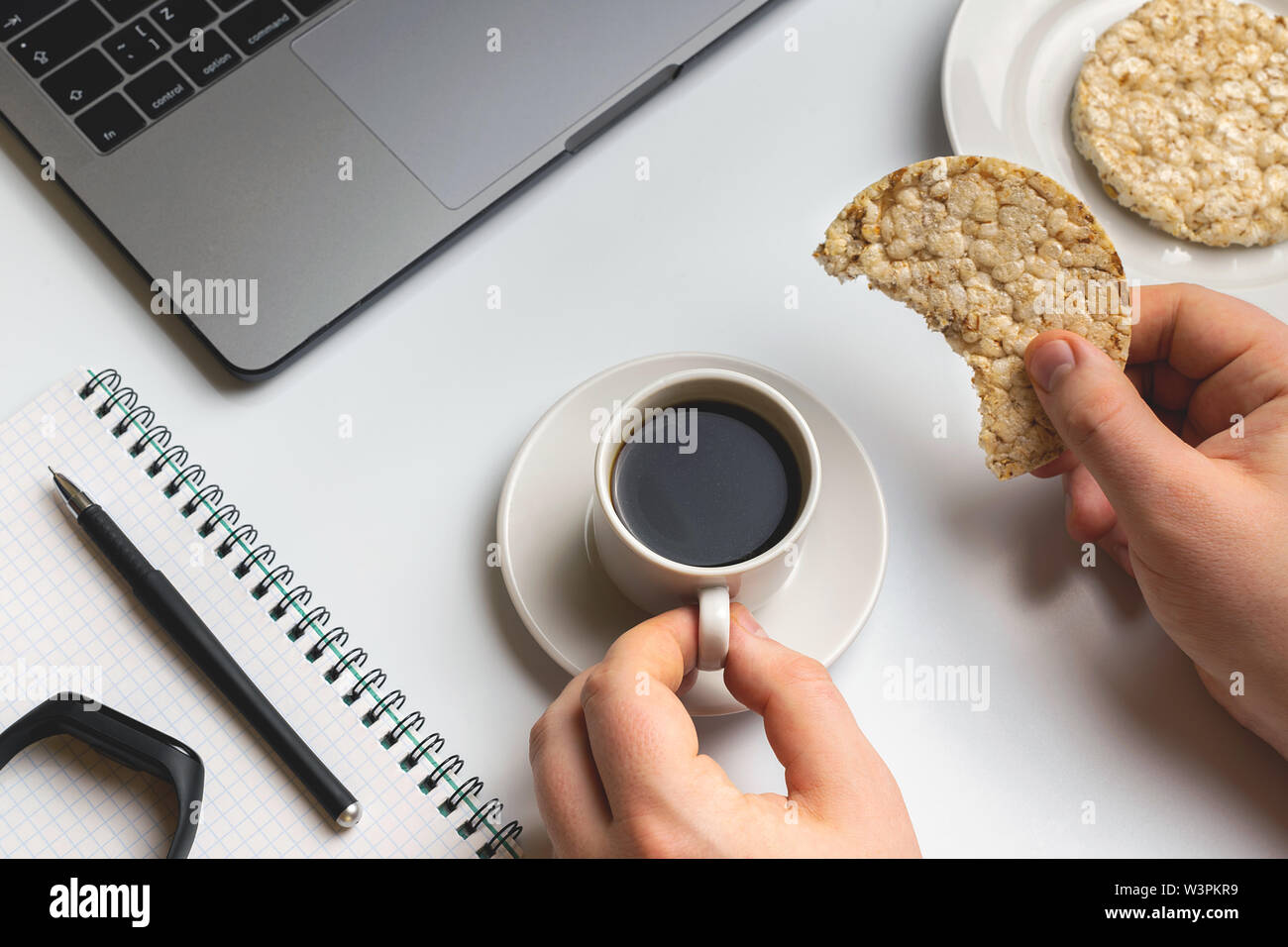 Healthy snacking at work during break time. Sportsman eating crispy ...