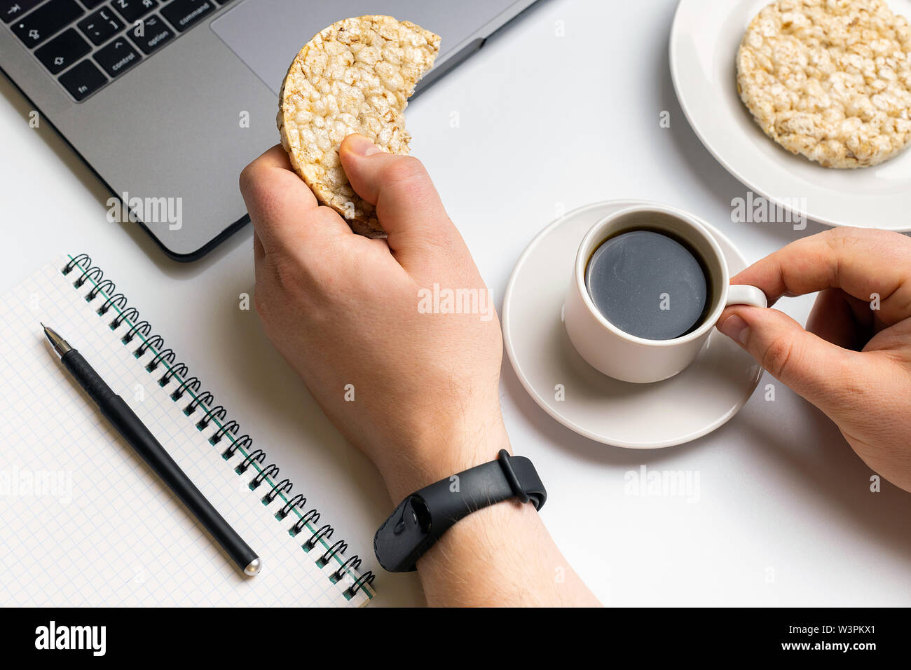 Healthy snacking at work during break time. Sportsman eating crispy ...