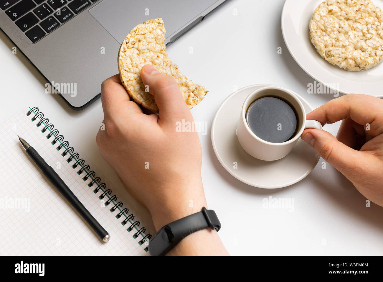 Healthy snacking at work during break time. Sportsman eating crispy ...