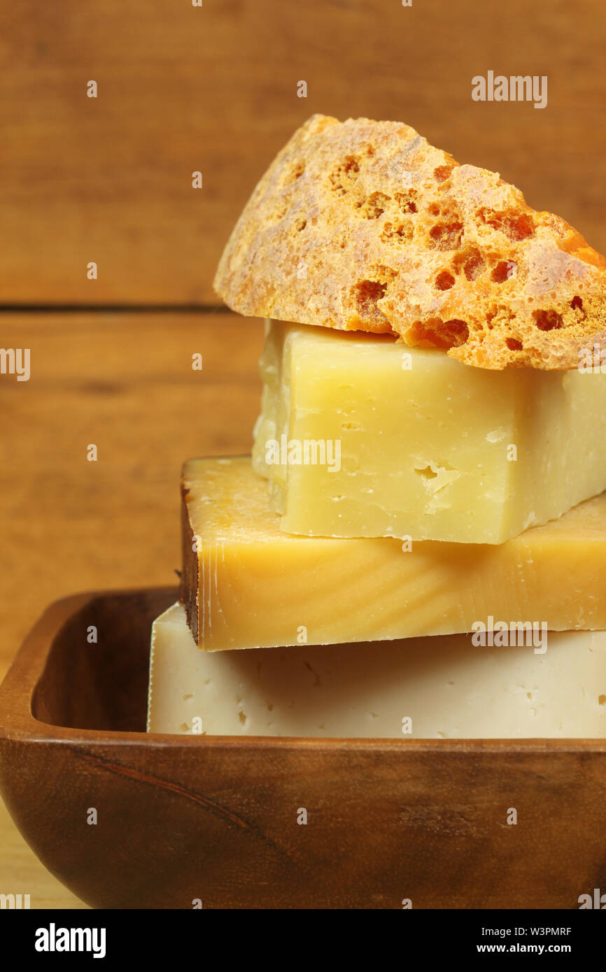 different kinds of cheese in pile. vertical photo Stock Photo - Alamy