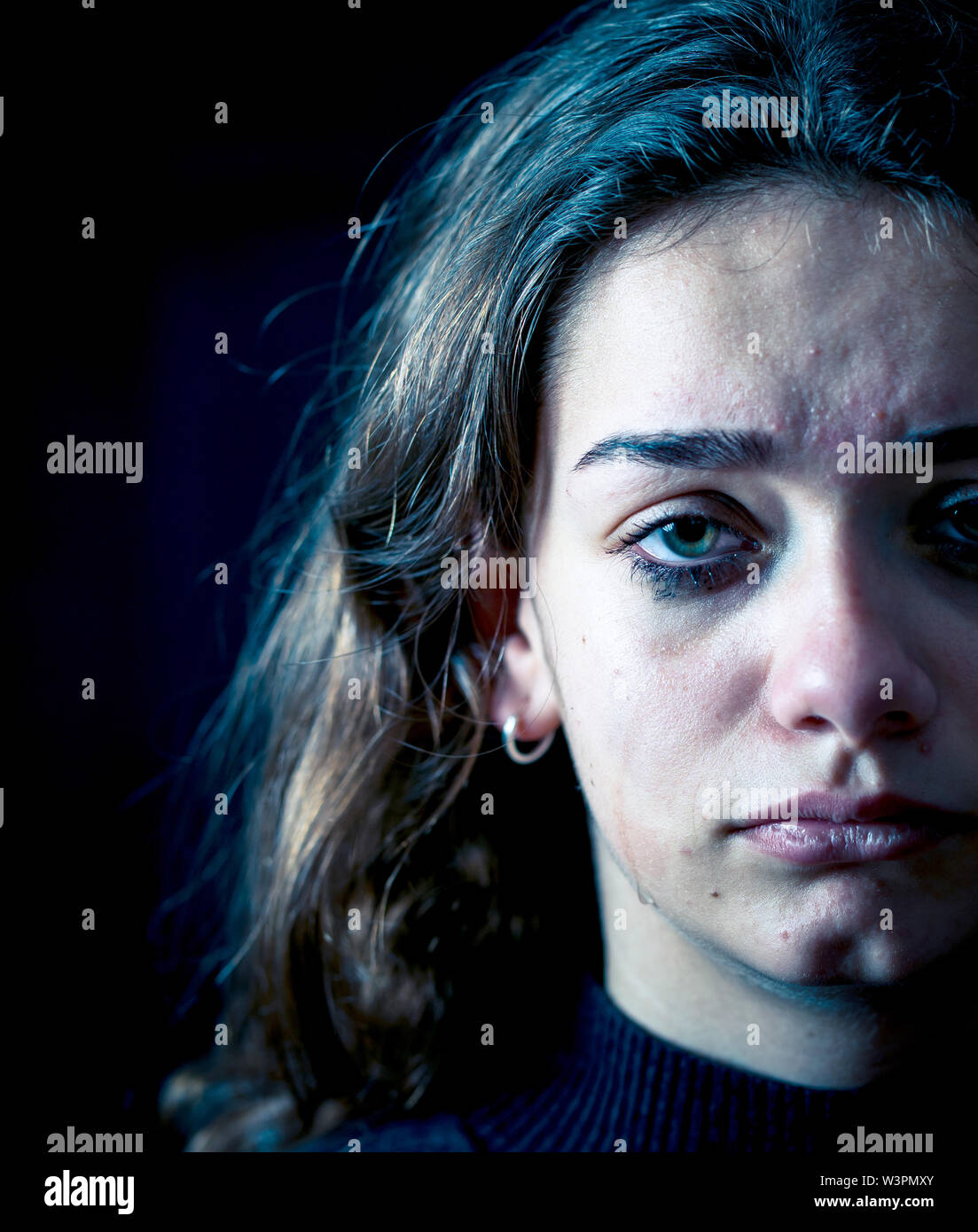 Closeup of a bullied, depressed, alone, tired, stressed young child ...