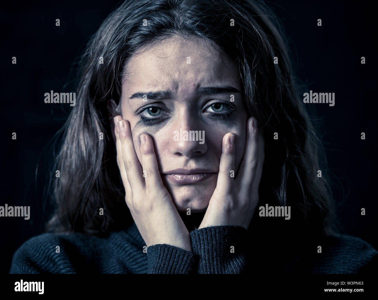 Dramatic closeup portrait of young scared, depressed girl crying alone ...