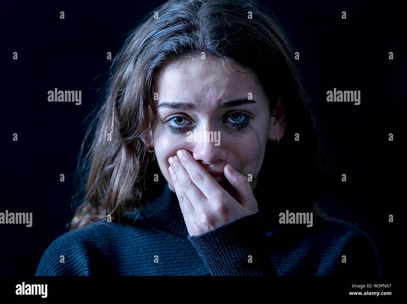 Dramatic closeup portrait of young scared, depressed girl crying alone ...
