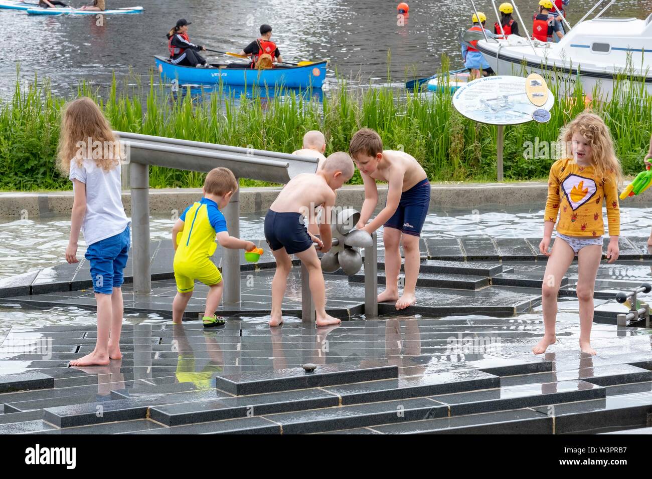 Children playing and splashing in water Stock Photo - Alamy