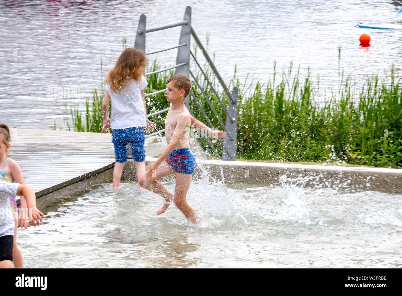 Children playing and splashing in water Stock Photo - Alamy