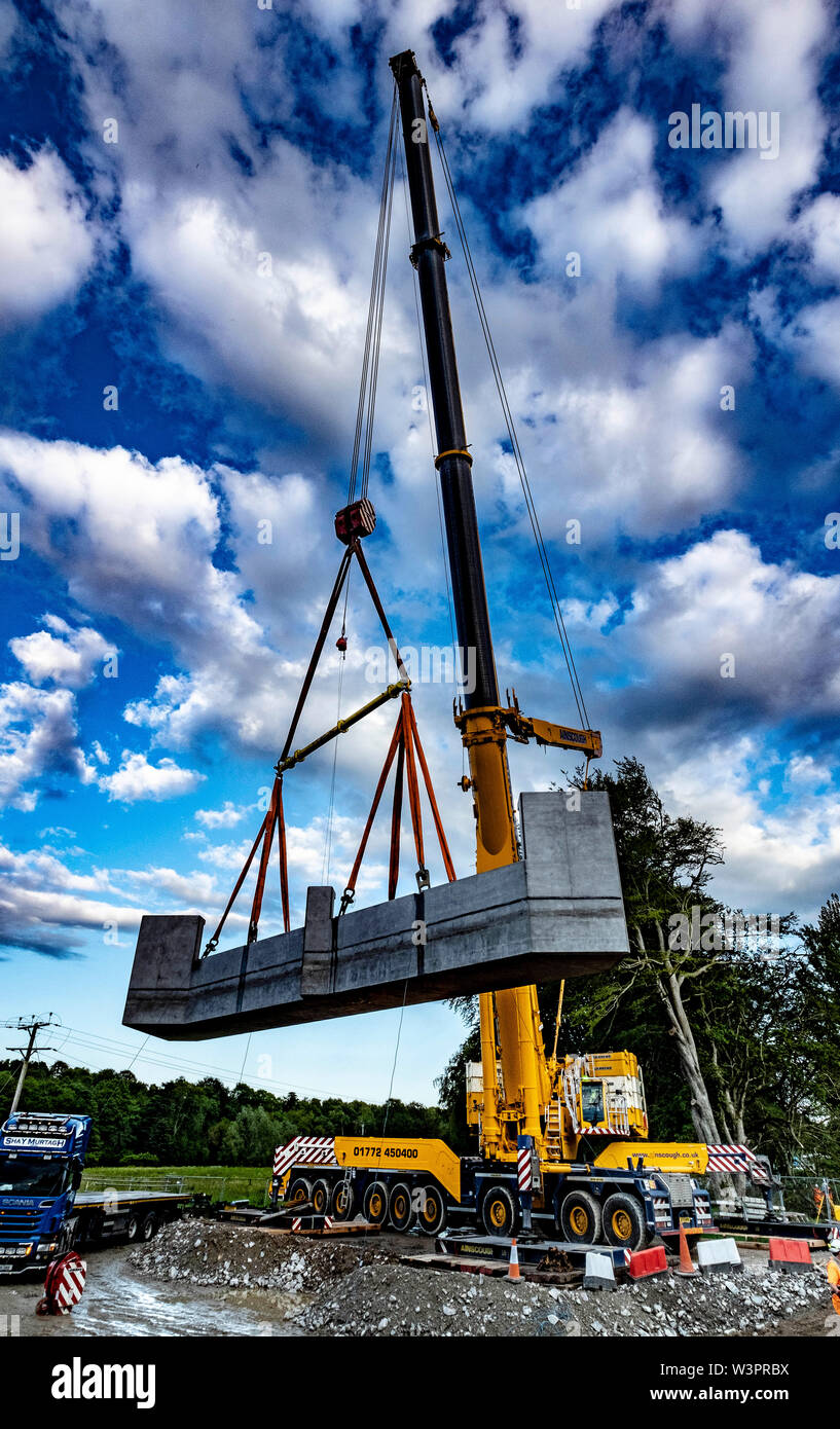Railway workers constructing railway and lifting rail bridge into place ...