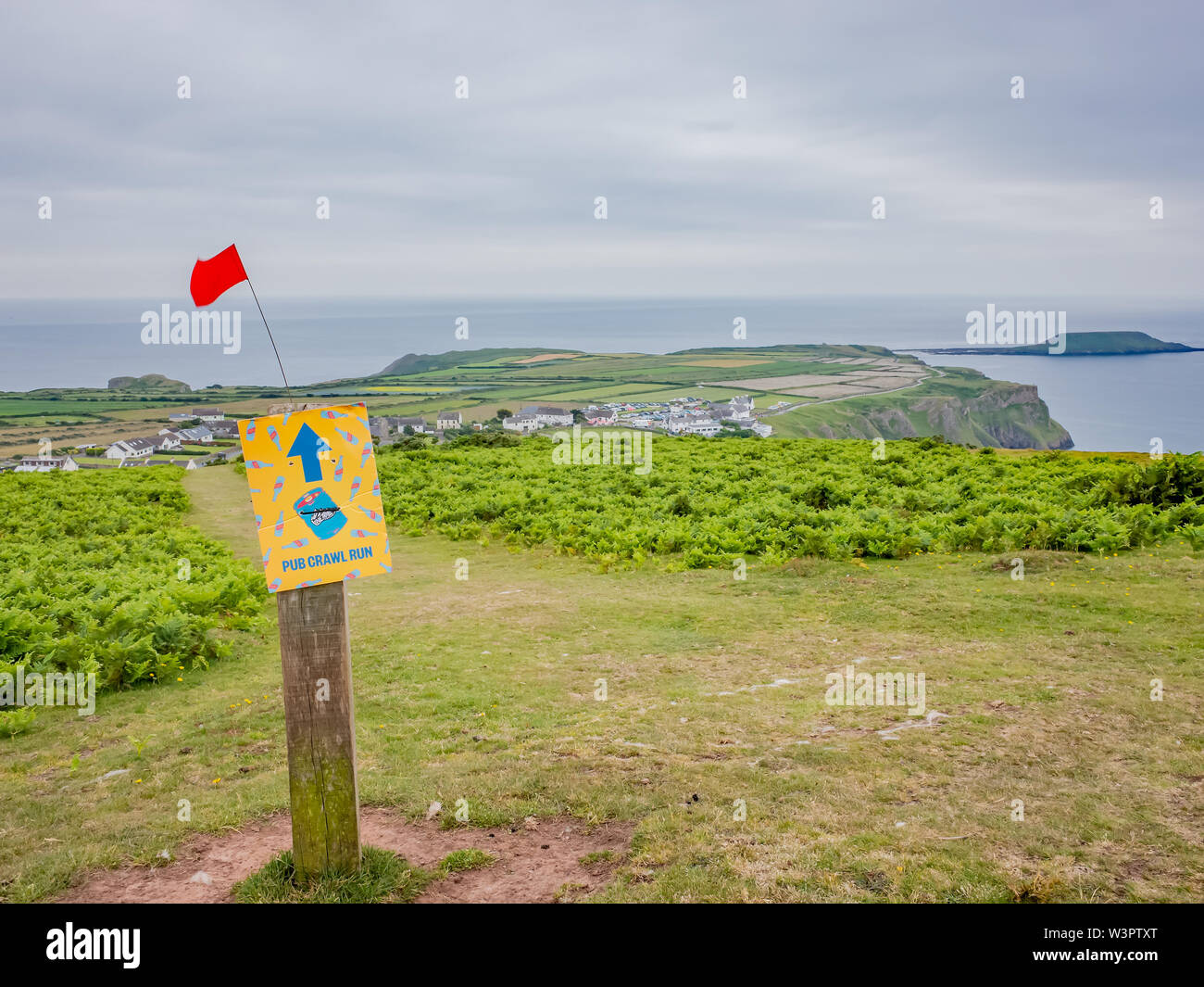 The “Pub Crawl Run” sign on Gower Way/Rhossili Down marking the route ...