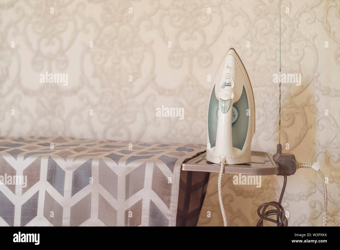 iron on a ironing board at home, housework and housekeeping idea Stock ...