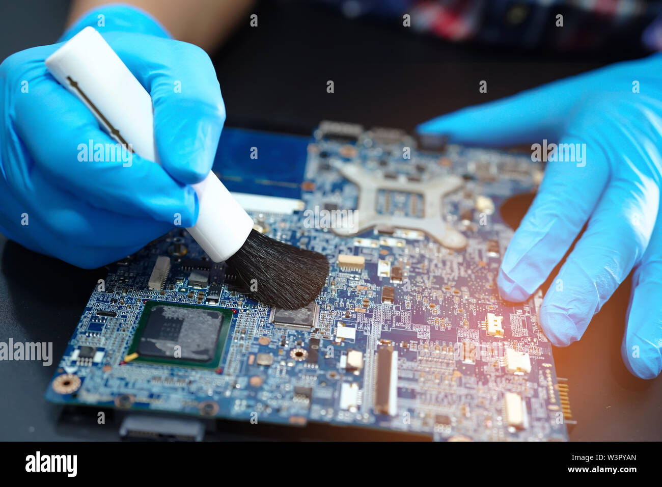 Asian Technician repair and cleaning dirty dust micro circuit main ...